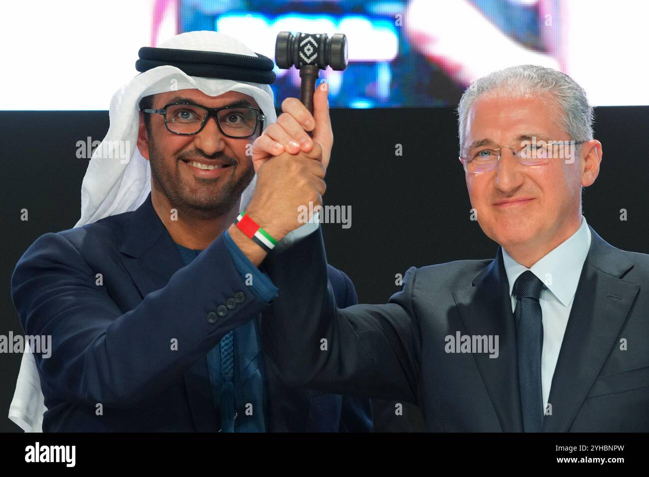 COP28 President Sultan al-Jaber, left, hands over the gavel to Mukhtar ...