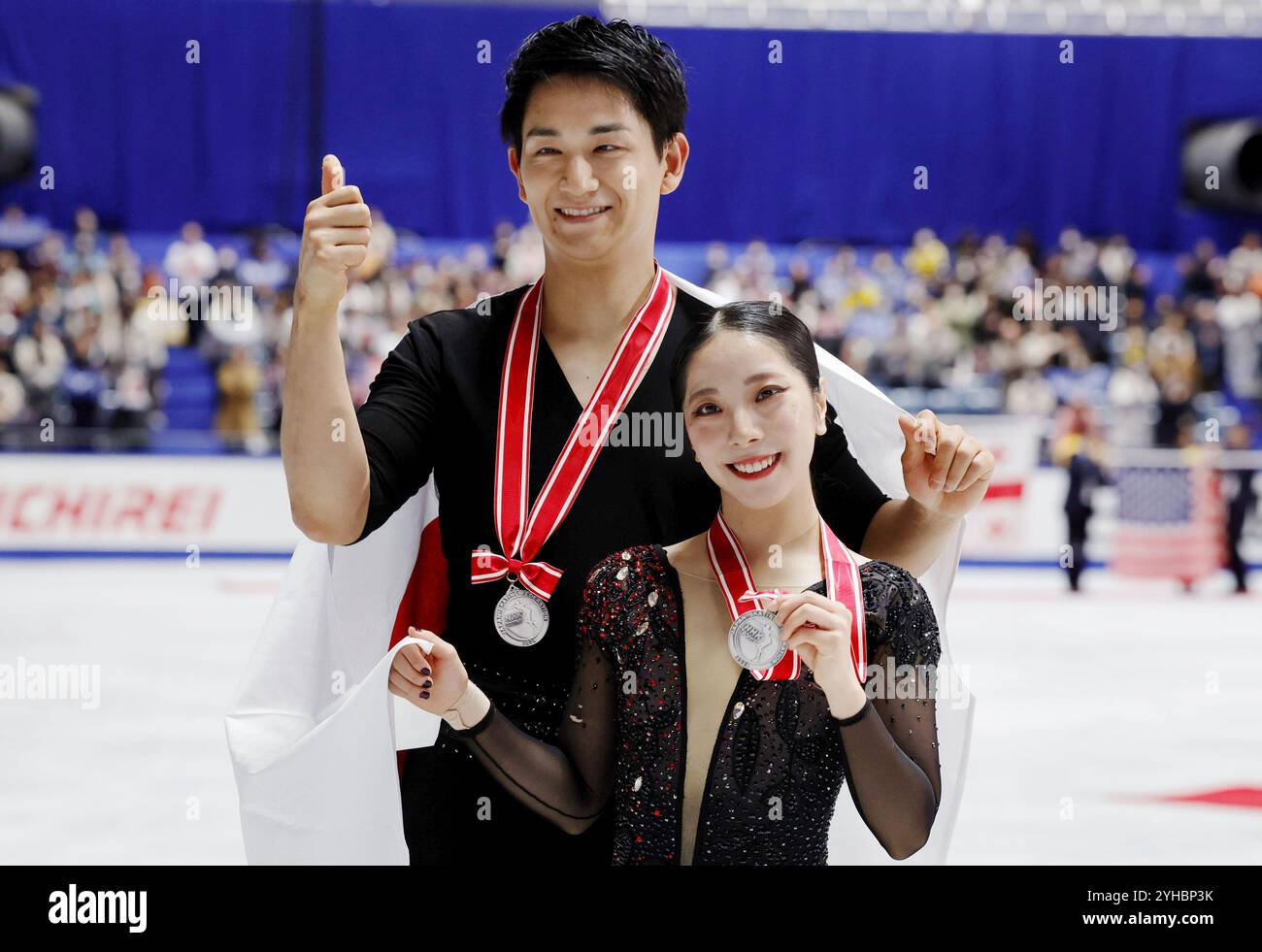 Japanese pair Riku Miura (R) and Ryuichi Kihara pose after winning silver at the NHK Trophy ...