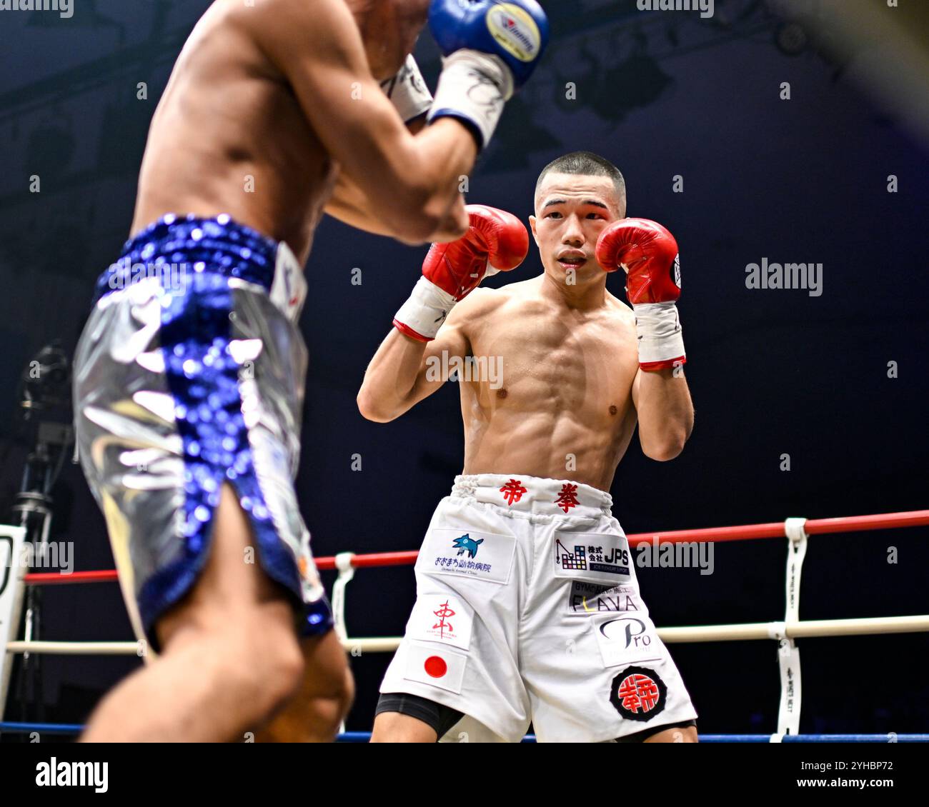 Riku Masuda (red gloves) and Yoshihiro Utsumi (blue gloves) compete during their the Japanese ...