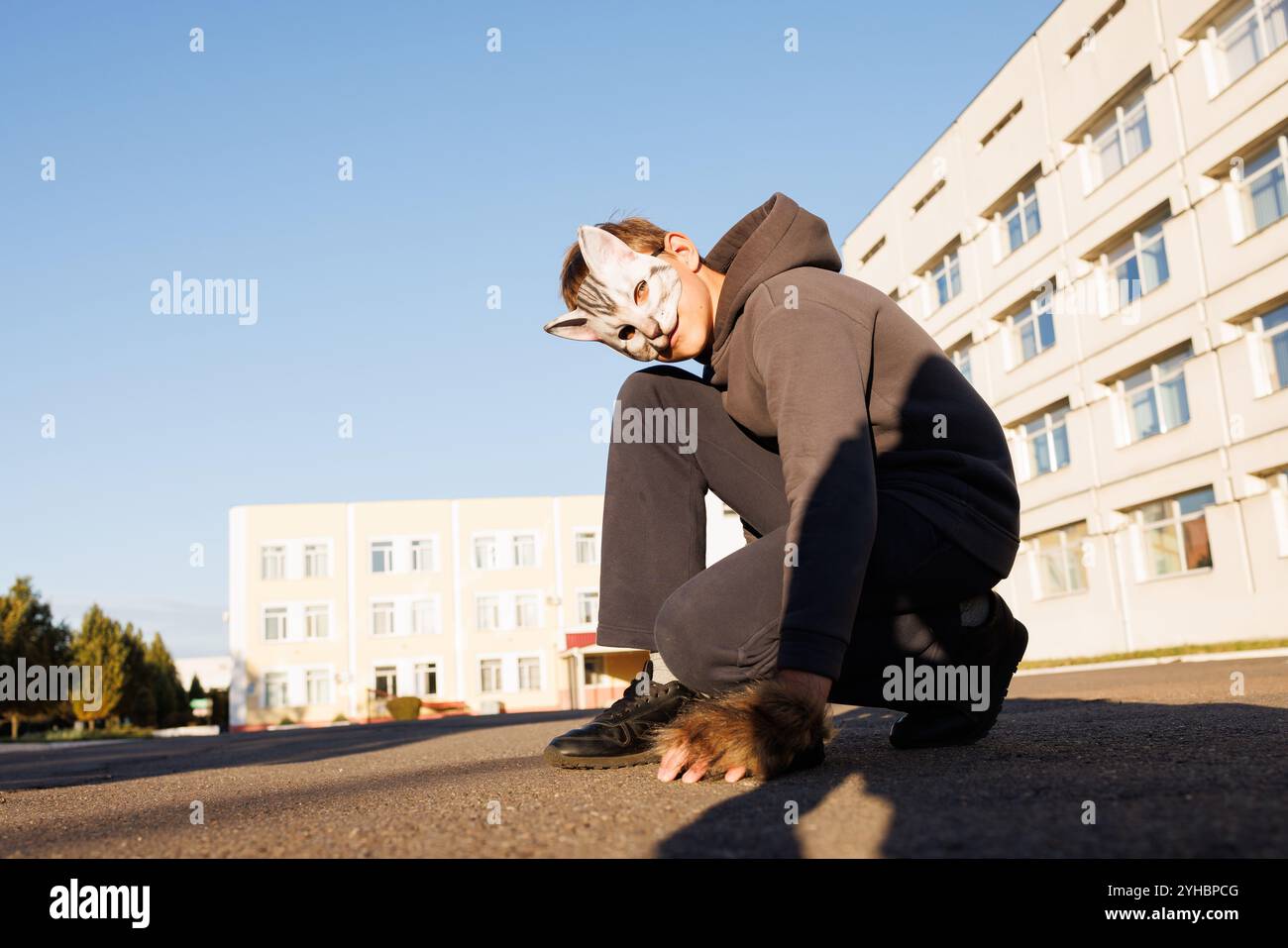 boy quadrober in cat mask sit in city, quadrober children, subculture ...