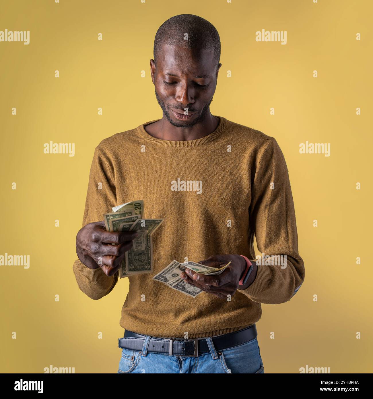 Young man is carefully counting his money hi-res stock photography and ...