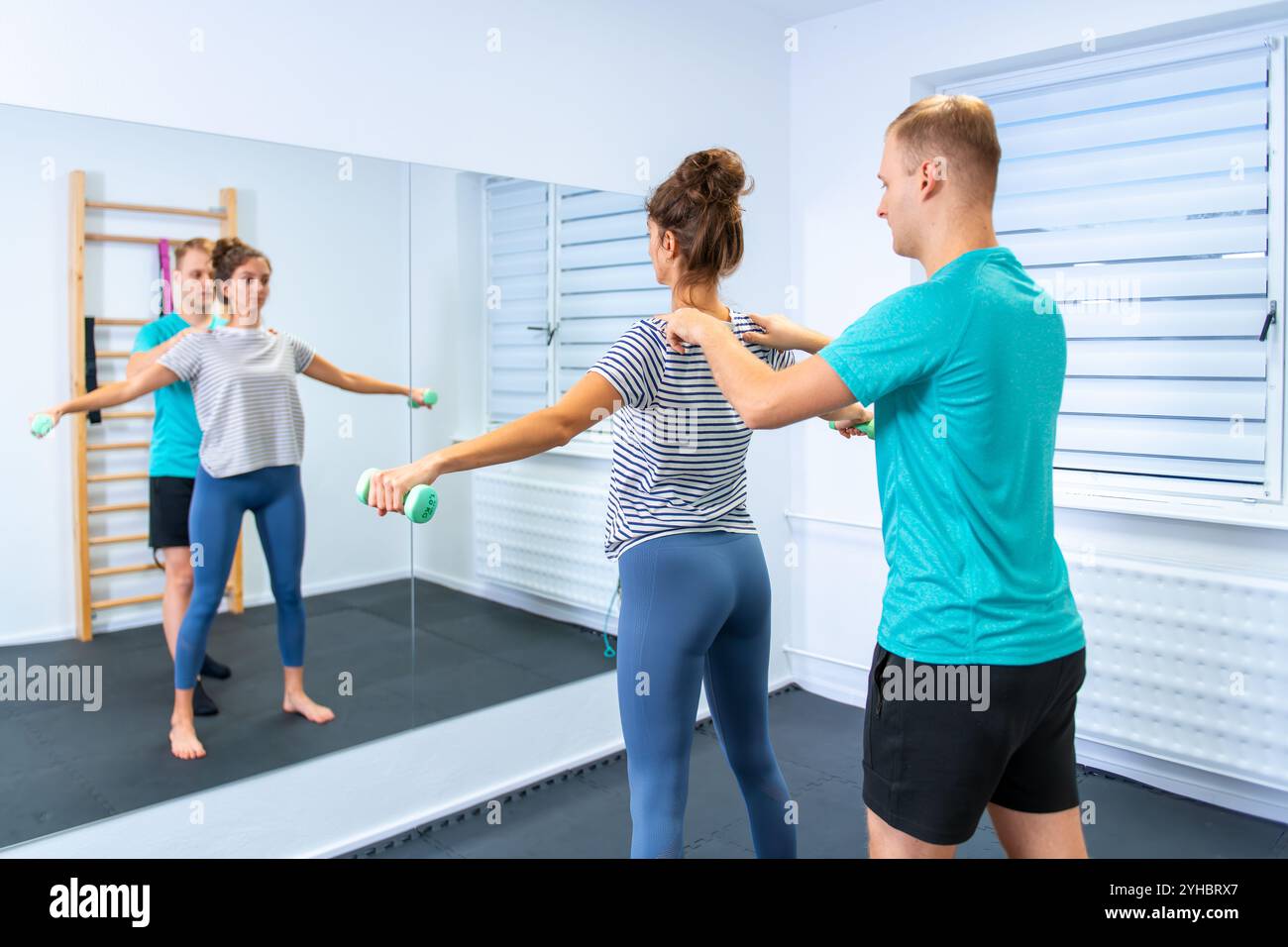 Woman with shoulder pain in physical therapy. Physical therapist ...