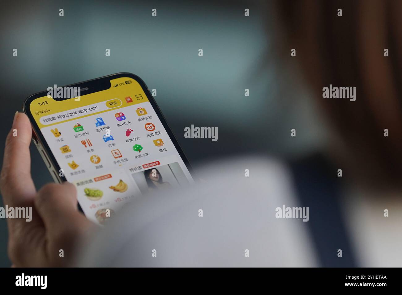 In this photo illustration, A woman browses the Meituan app on her ...