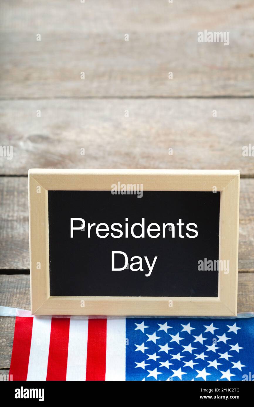 the text happy presidents day written in a chalkboard and a flag of the ...