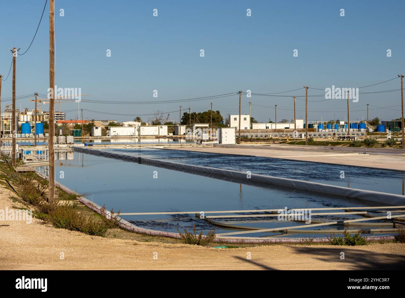 Open air algae farm reflecting blue sky at algatec eco business park ...