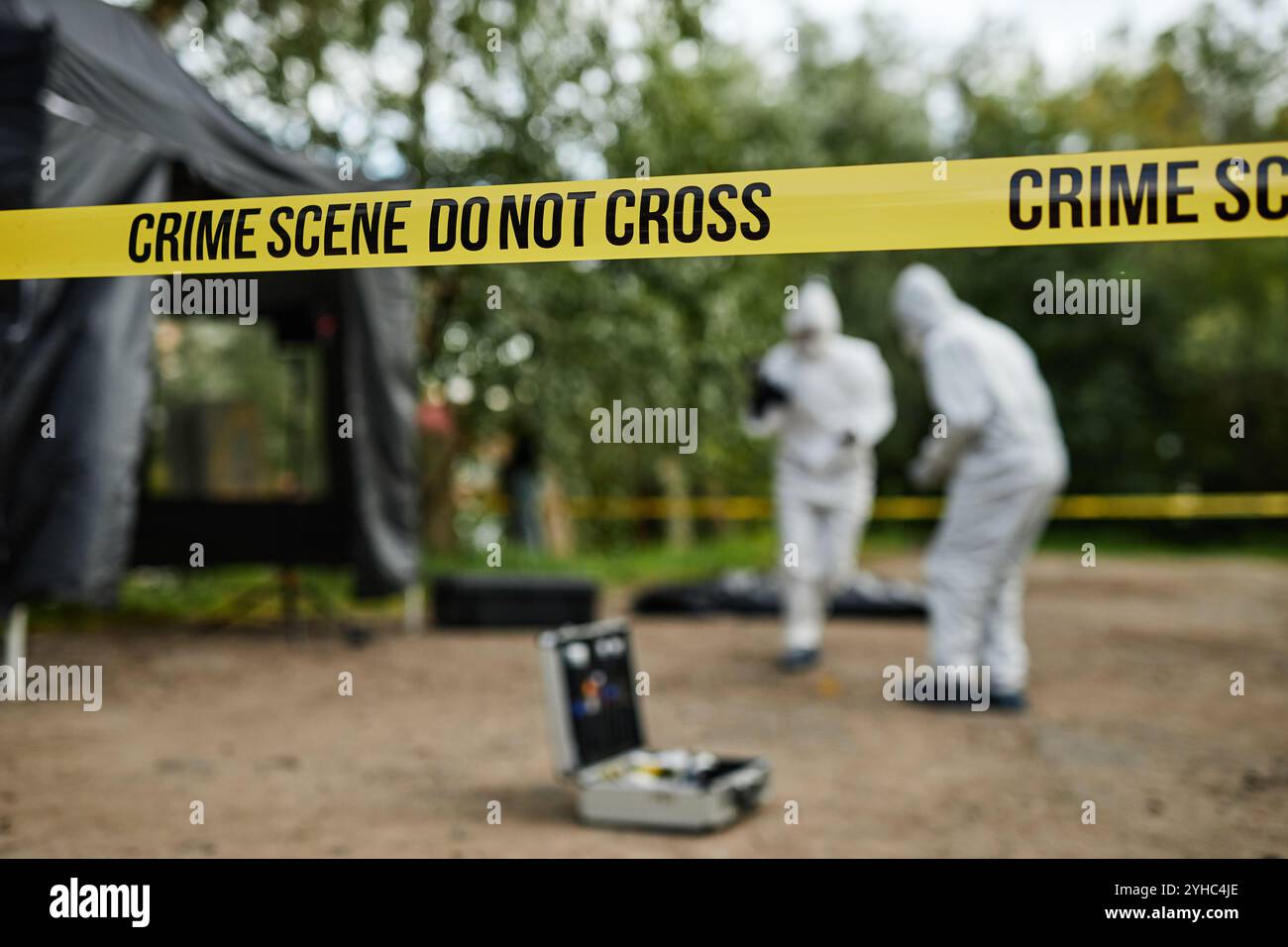 Background image of crime scene with yellow Do not cross tape and ...