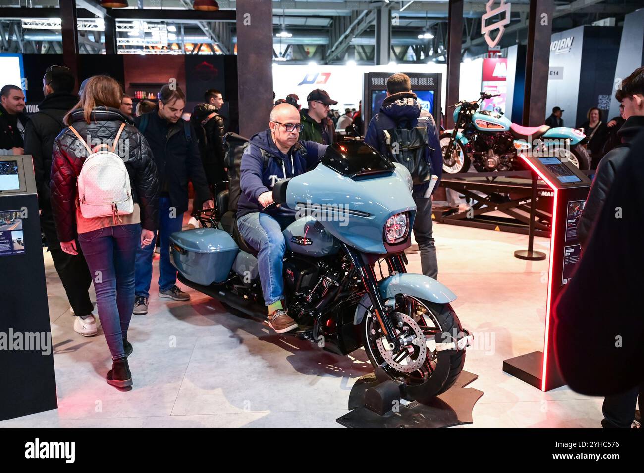 Visitors look at Harley-Davidson motorbikes on display at EICMA, the ...