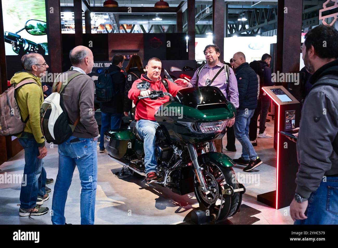 Visitors look at Harley-Davidson motorbikes on display at EICMA, the ...
