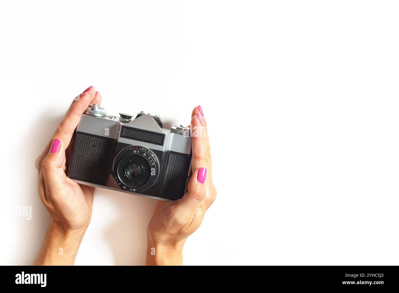 female hands hold vintage camera on white background Stock Photo - Alamy