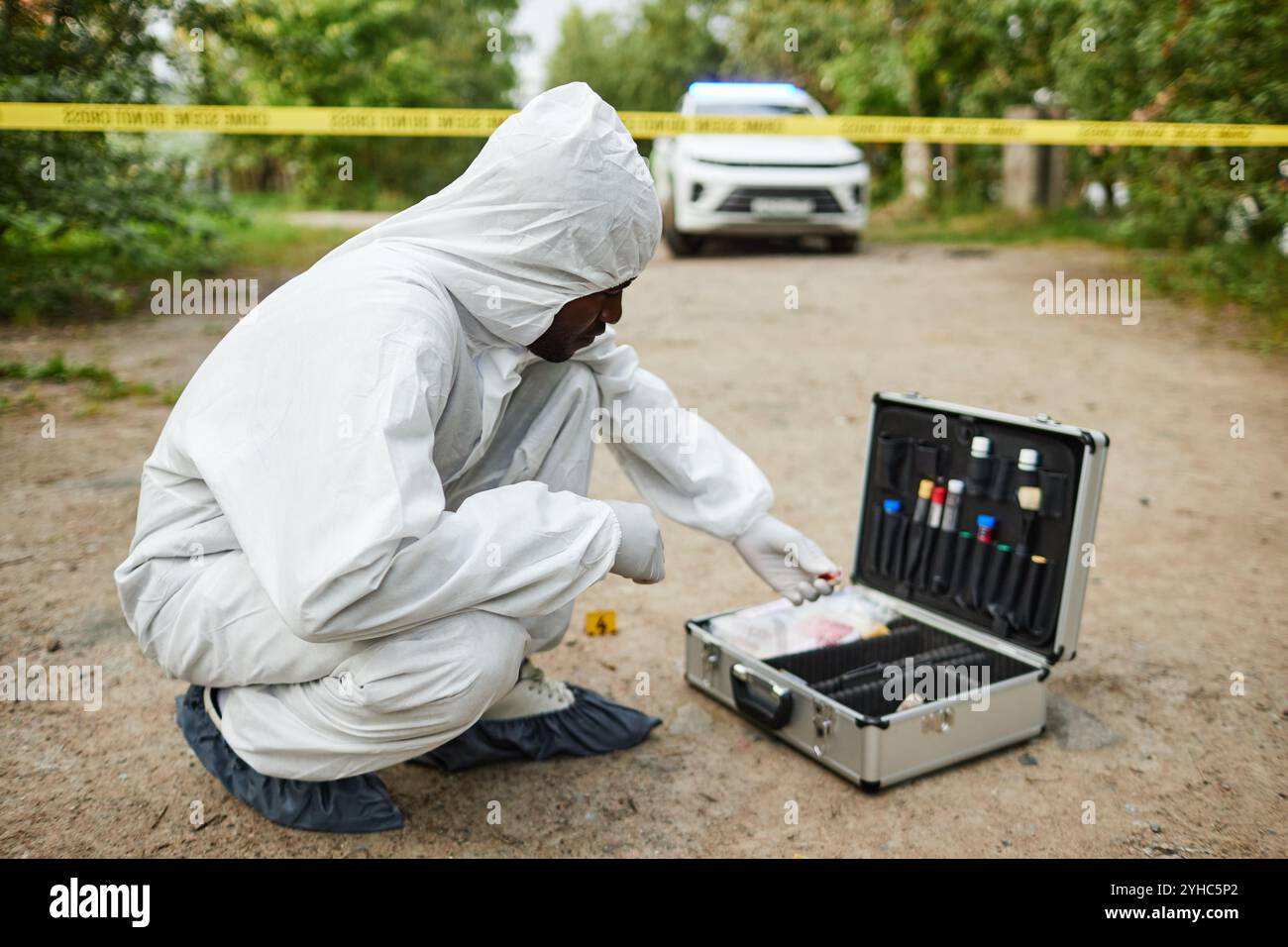 Full length side view of African American man wearing hazmat suit as ...