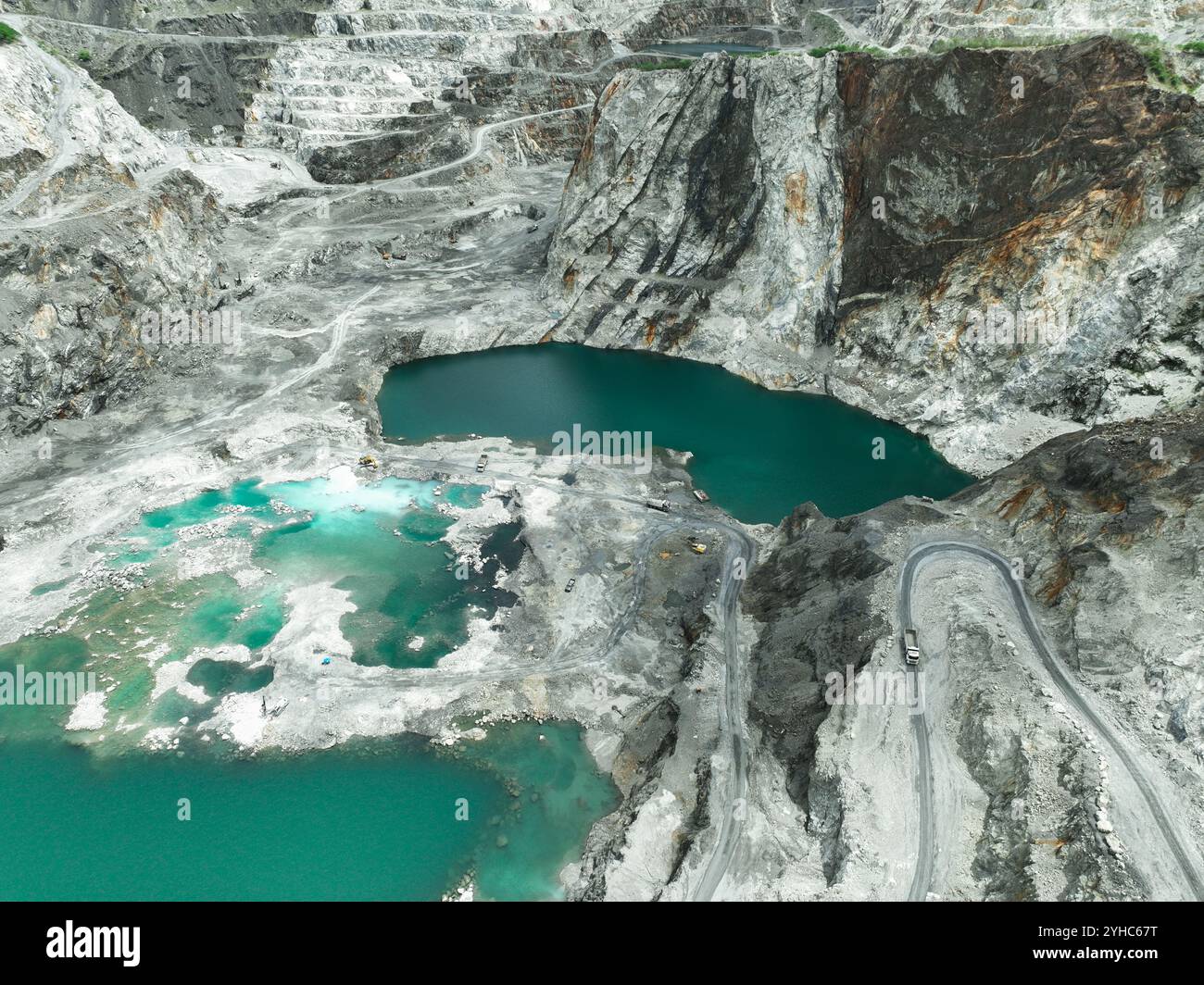 Large limestone quarry operation. Industrial trucks working at open pit ...