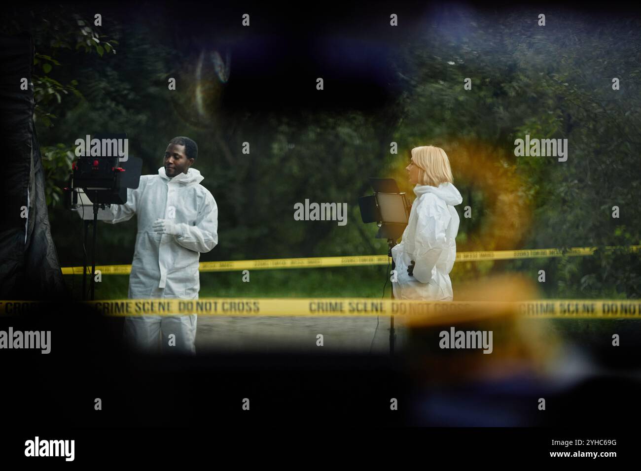 Wide angle shot of two investigators working at crime scene shot from ...