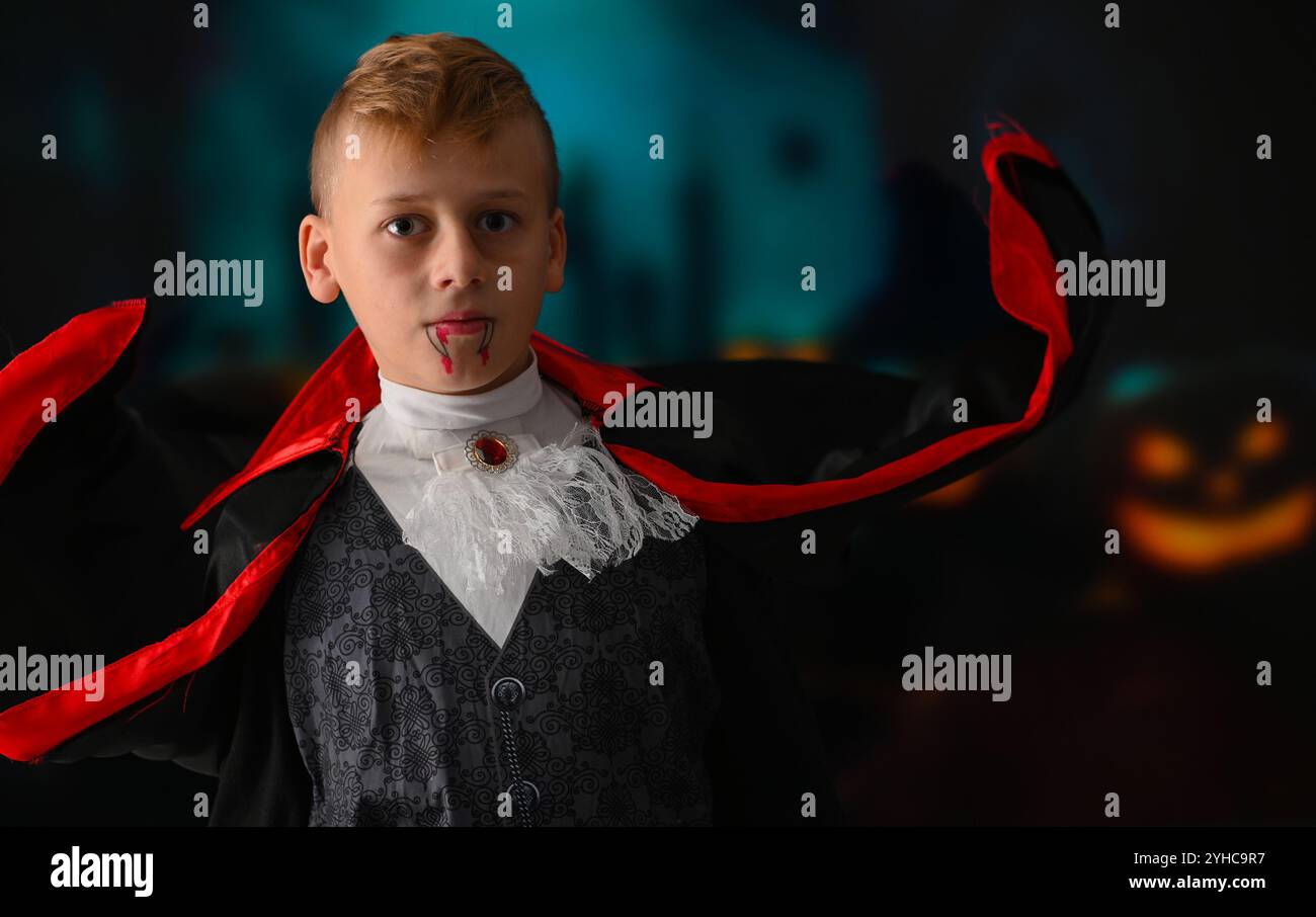 Child dressed as a vampire posing in front of a blurred background with ...