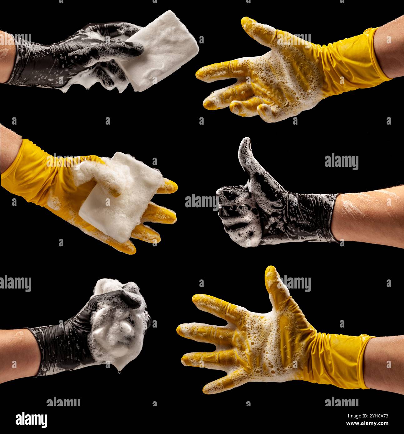 Hands in black and yellow rubber gloves covered in soapy foam. The left hands is holding a white ...