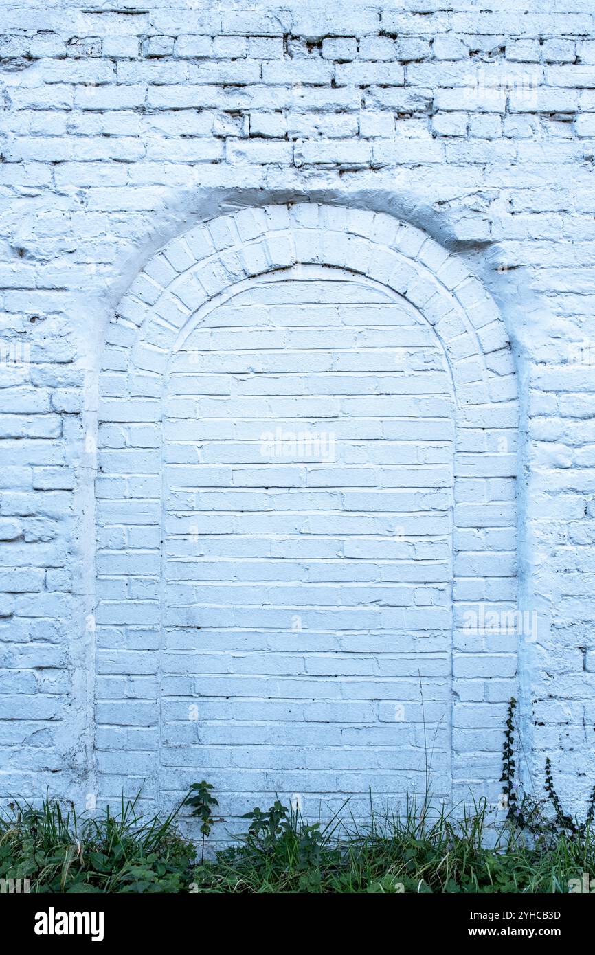 White painted bricked up entrance to building Stock Photo - Alamy