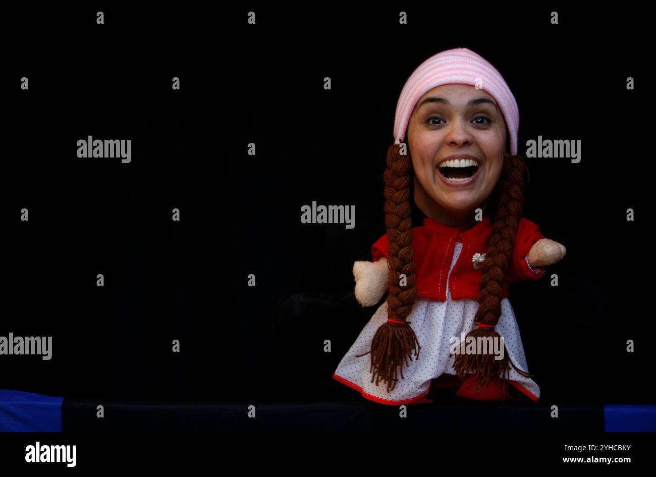 An actress dressed as a girl smiles during a puppet show in Mexico City ...