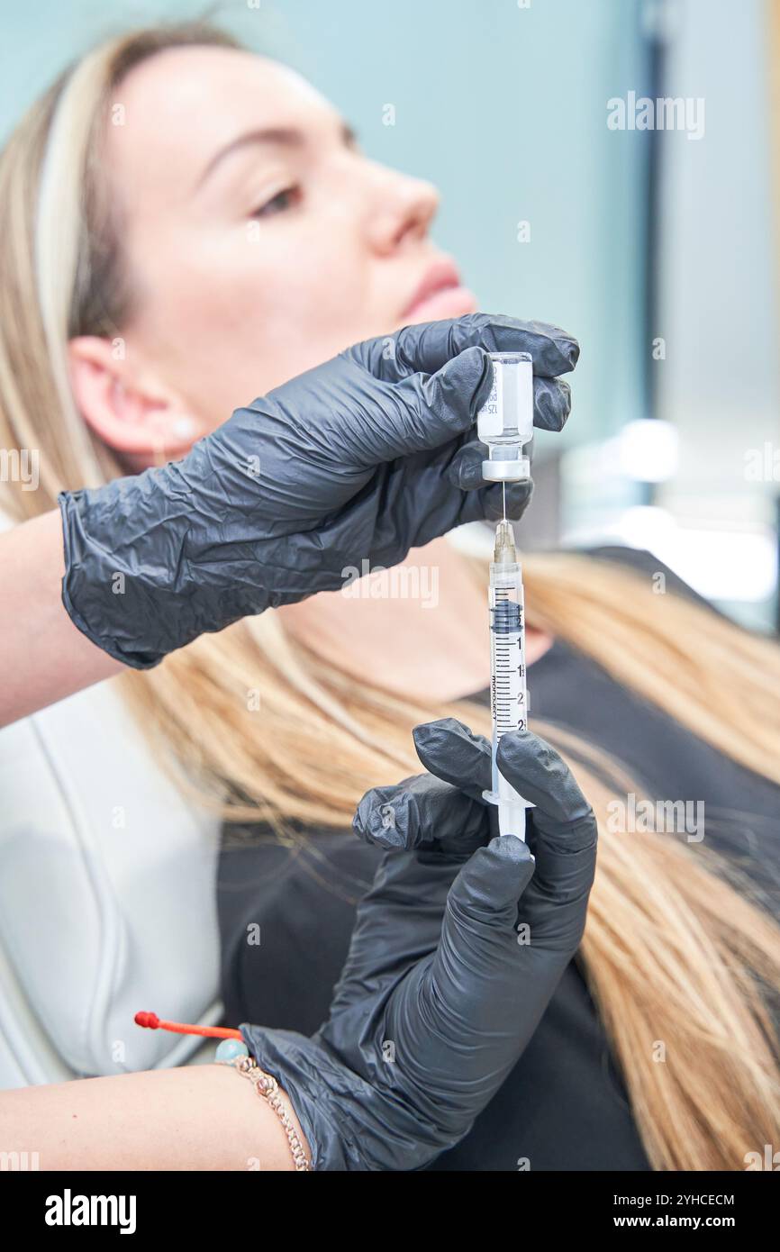A woman is carrying a syringe. The syringe is white and the woman is ...