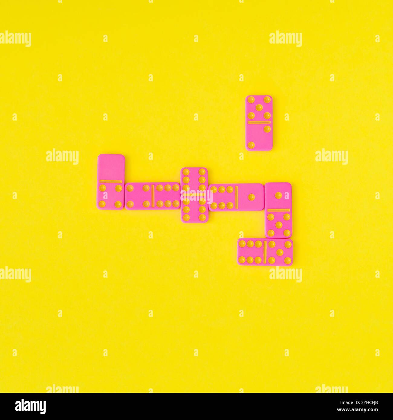 Pink dominoes on yellow background. Minimal board game concept. Trendy ...