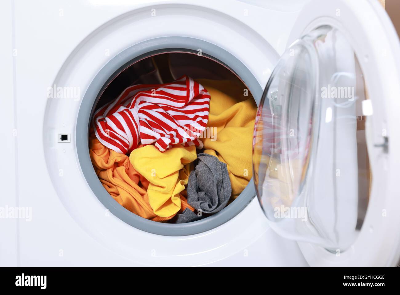 Modern washing machine with clothes in drum, closeup Stock Photo - Alamy