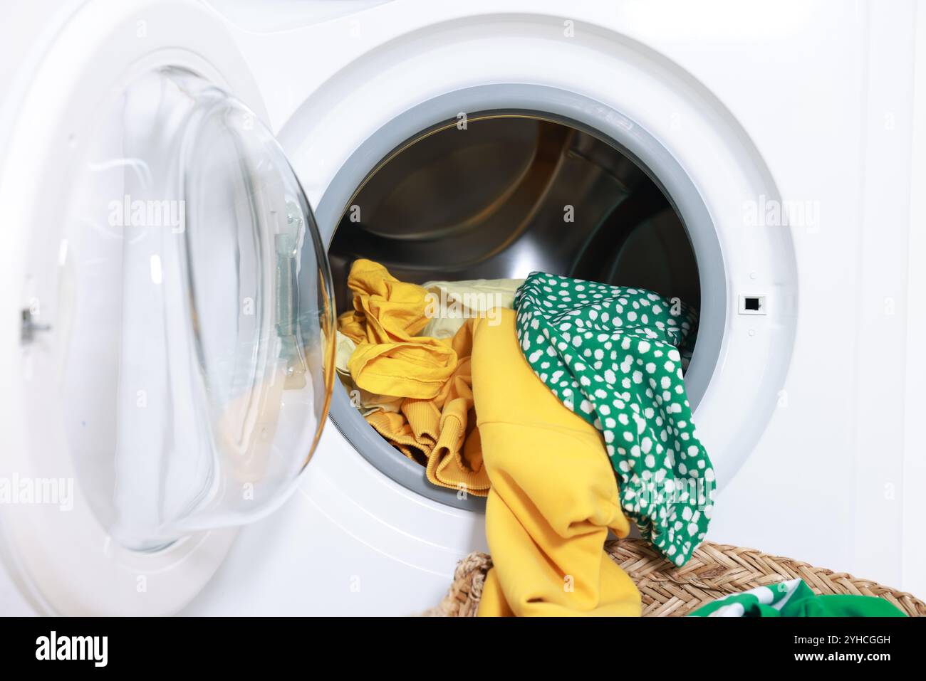 Modern washing machine with clothes in drum, closeup Stock Photo - Alamy