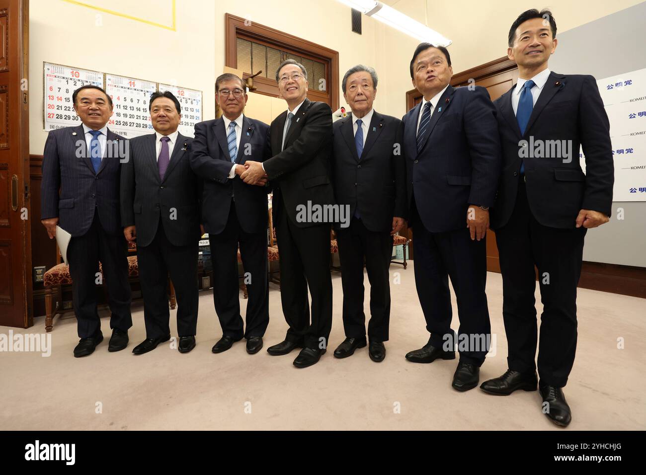Prime Minister Shigeru Ishiba(L) shakes his hand with Komeito leader ...