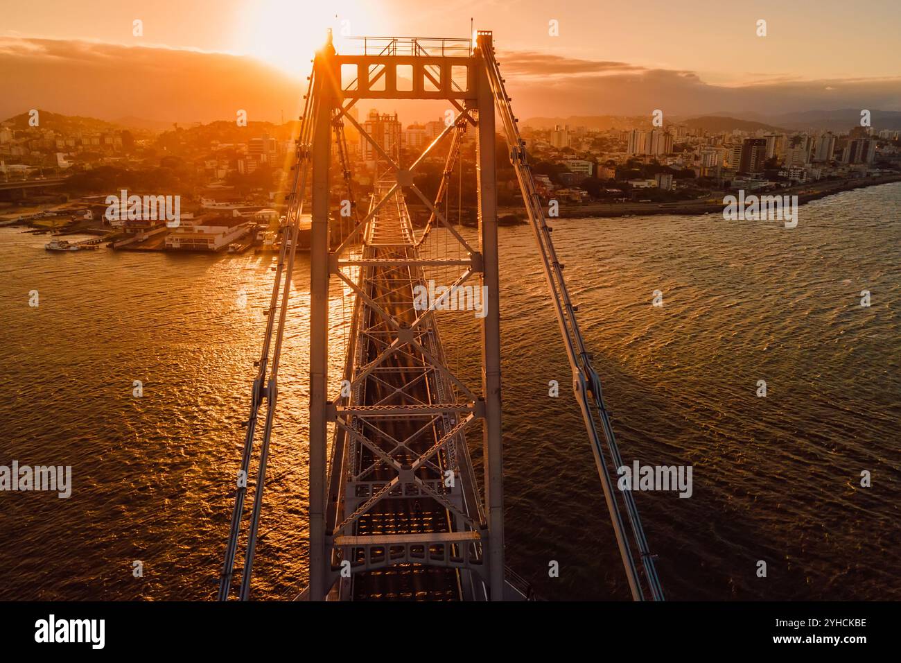 Aerial view of city and cable stayed bridge with bright sunset in ...