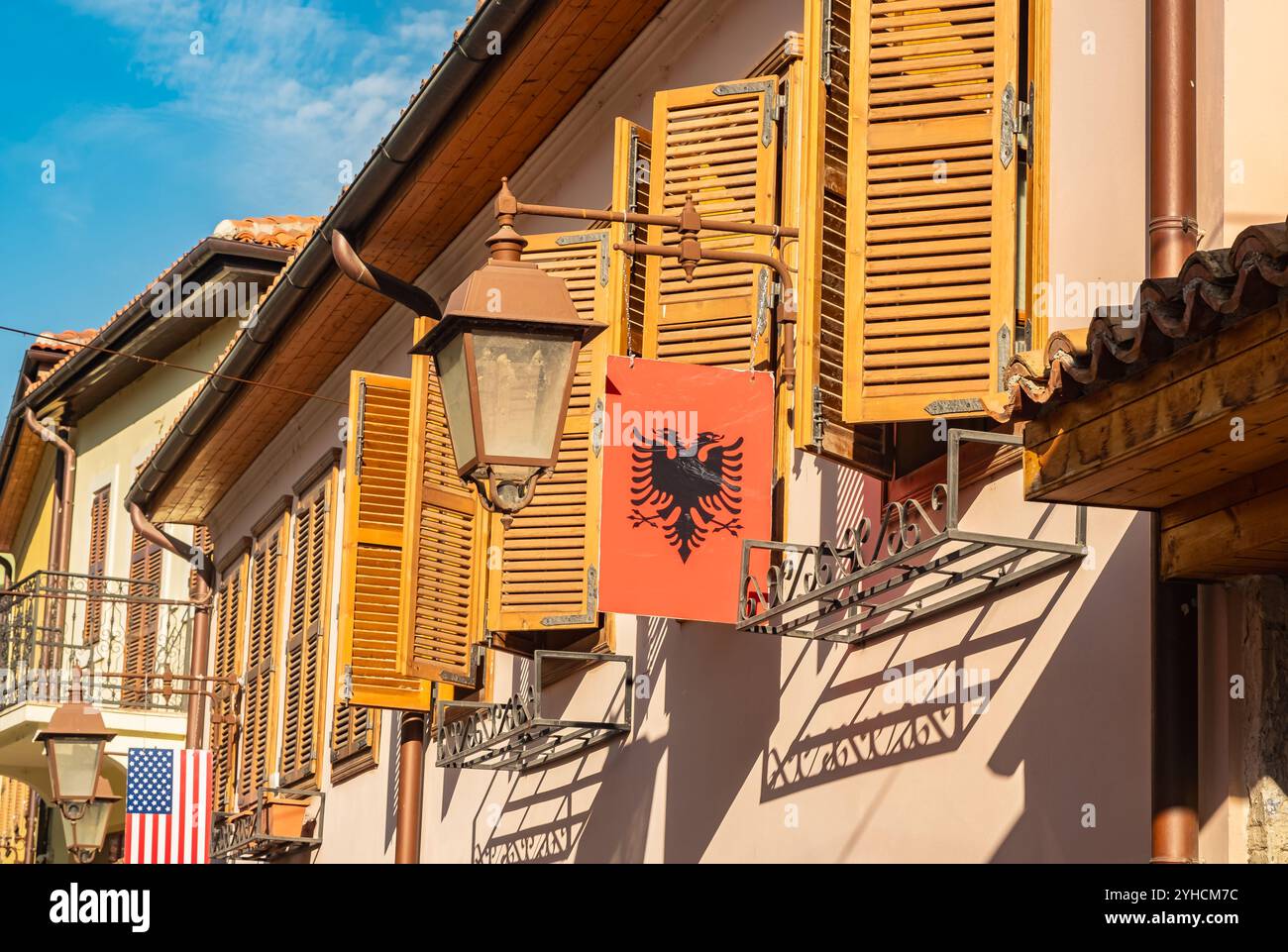The flag of Albania hanging of the facade of houses of the old town in ...
