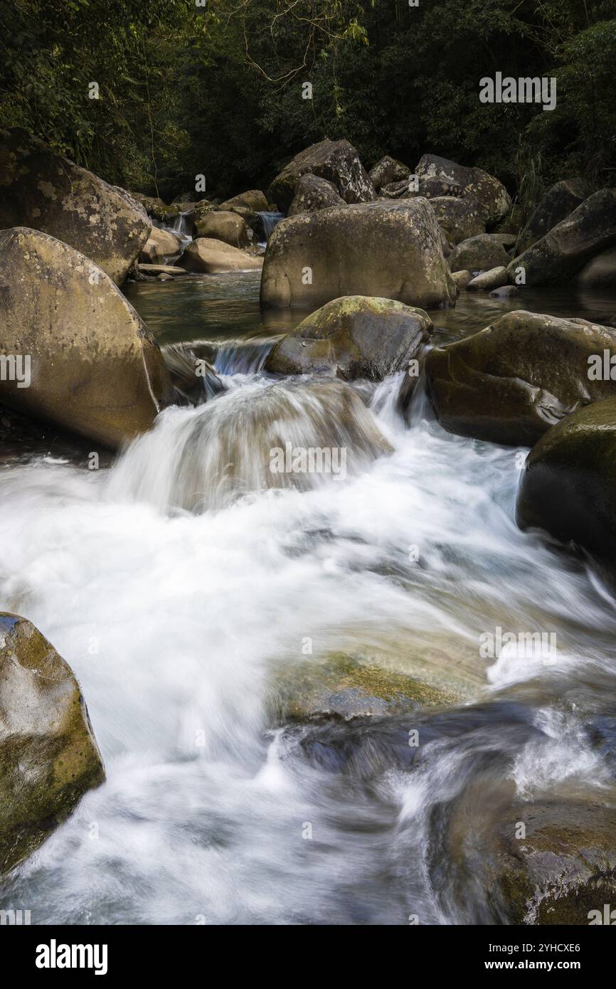 Slow shutter image of water flowing through the rocks creating a smooth ...