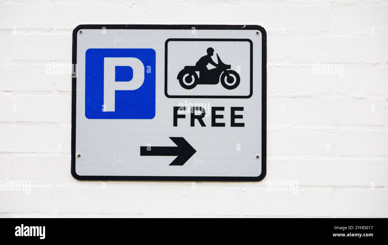 Free motorcycle parking sign on white painted brick wall. Flamborough ...