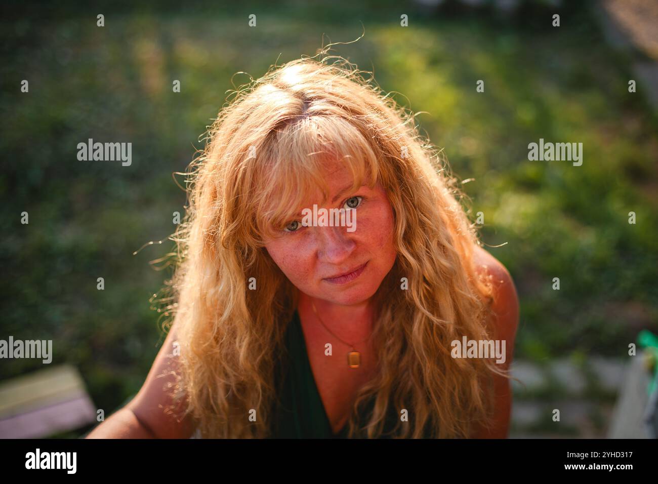 A portrait of a Slavic woman with light golden hair glistening in the ...