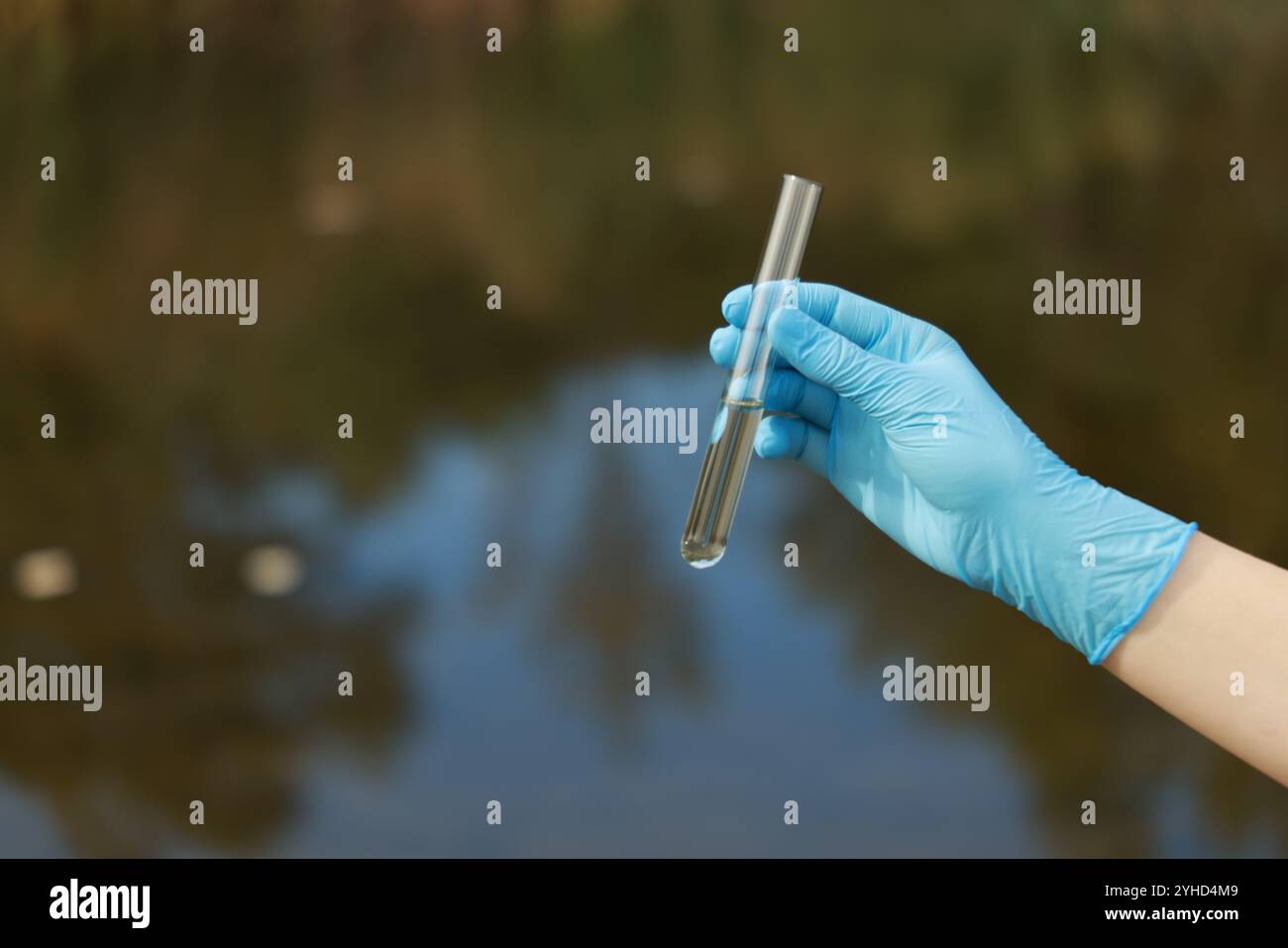 Examination of water quality. Researcher holding test tube with sample ...