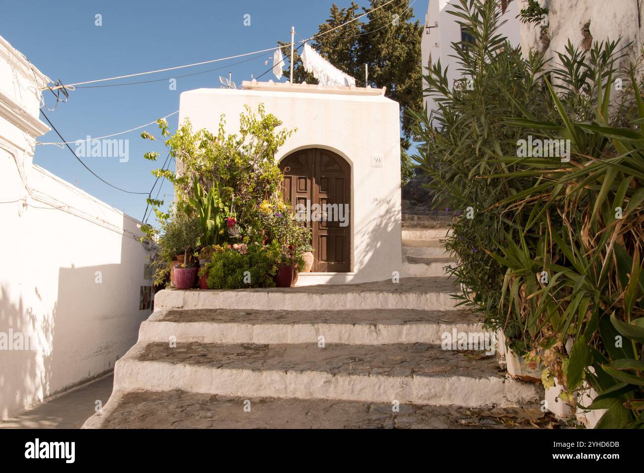 Beautiful Greek Street with summer flowers in Lindos village Stock ...