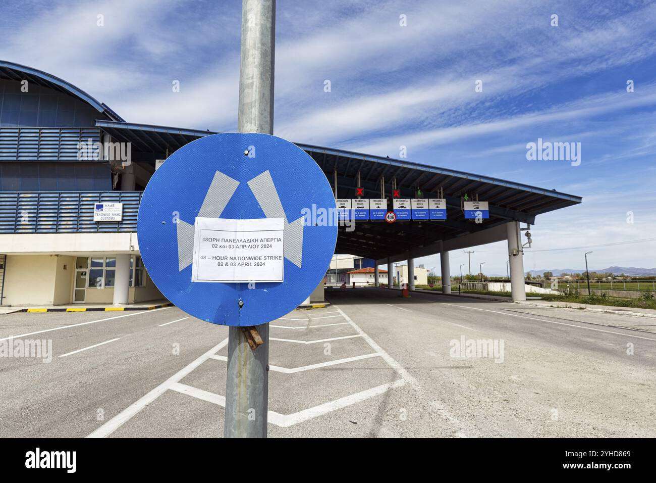 Notice on traffic sign informing travellers, deserted border crossing ...