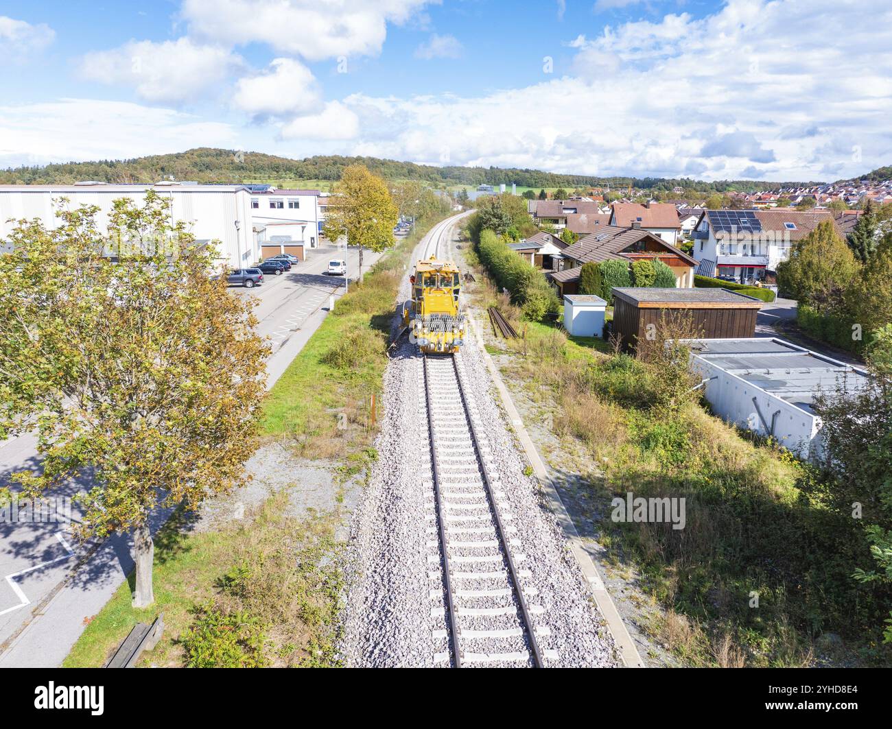 Train maintenance vehicle on the tracks between residential houses and ...