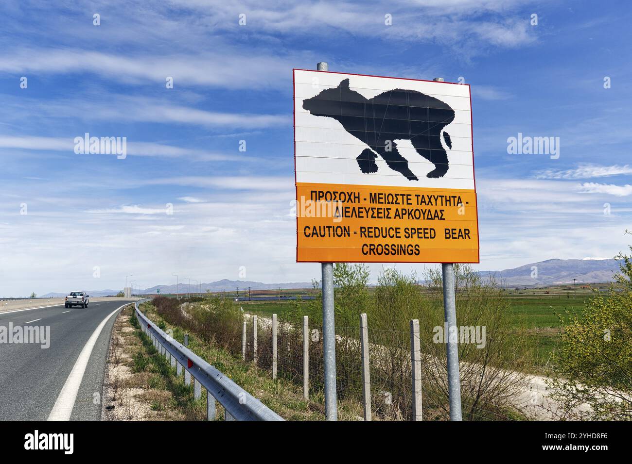 Bilingual warning sign on motorway, caution, drive slowly, bears ...