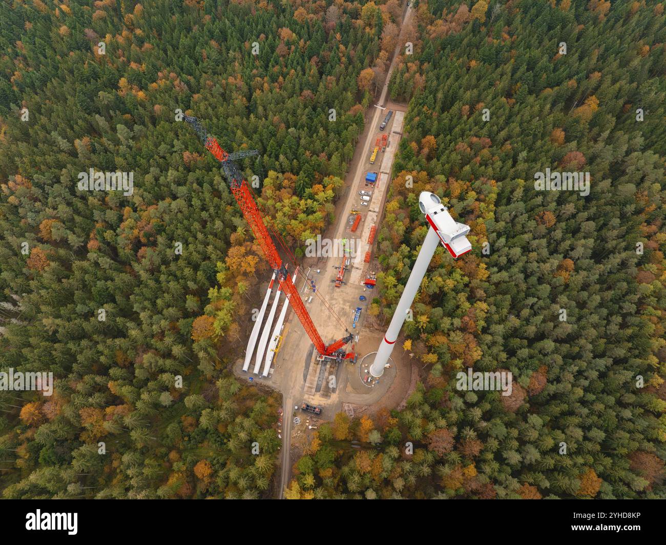 Large construction site of a wind power project in a dense, autumnal ...