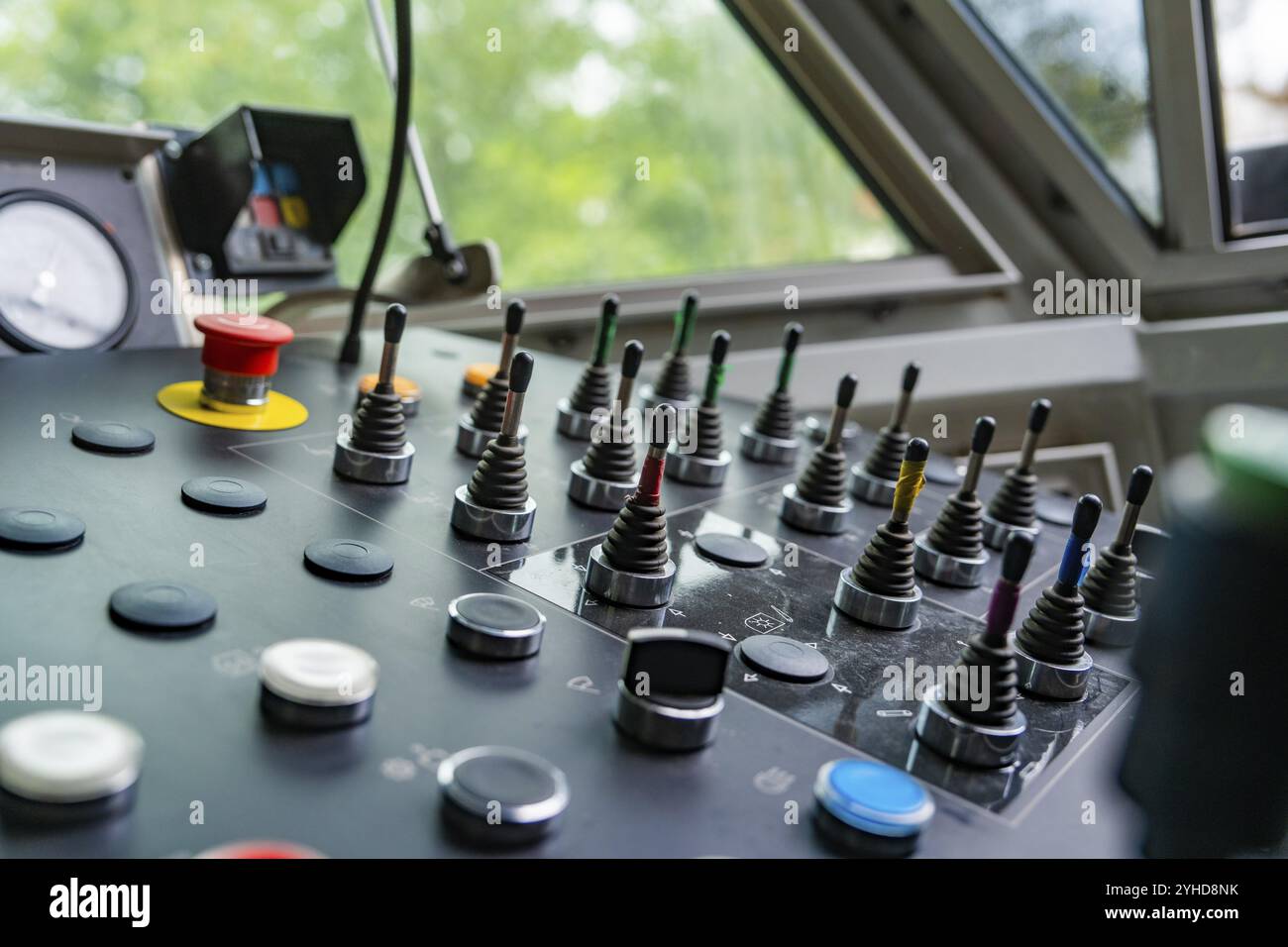 Industrial control panel with levers and various buttons, close-up ...