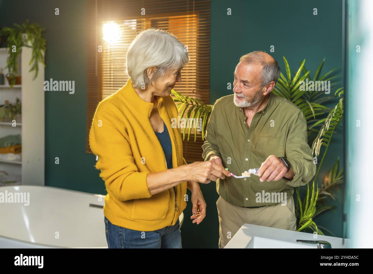 Happy caucasian senior couple washing teeth together at home Stock ...