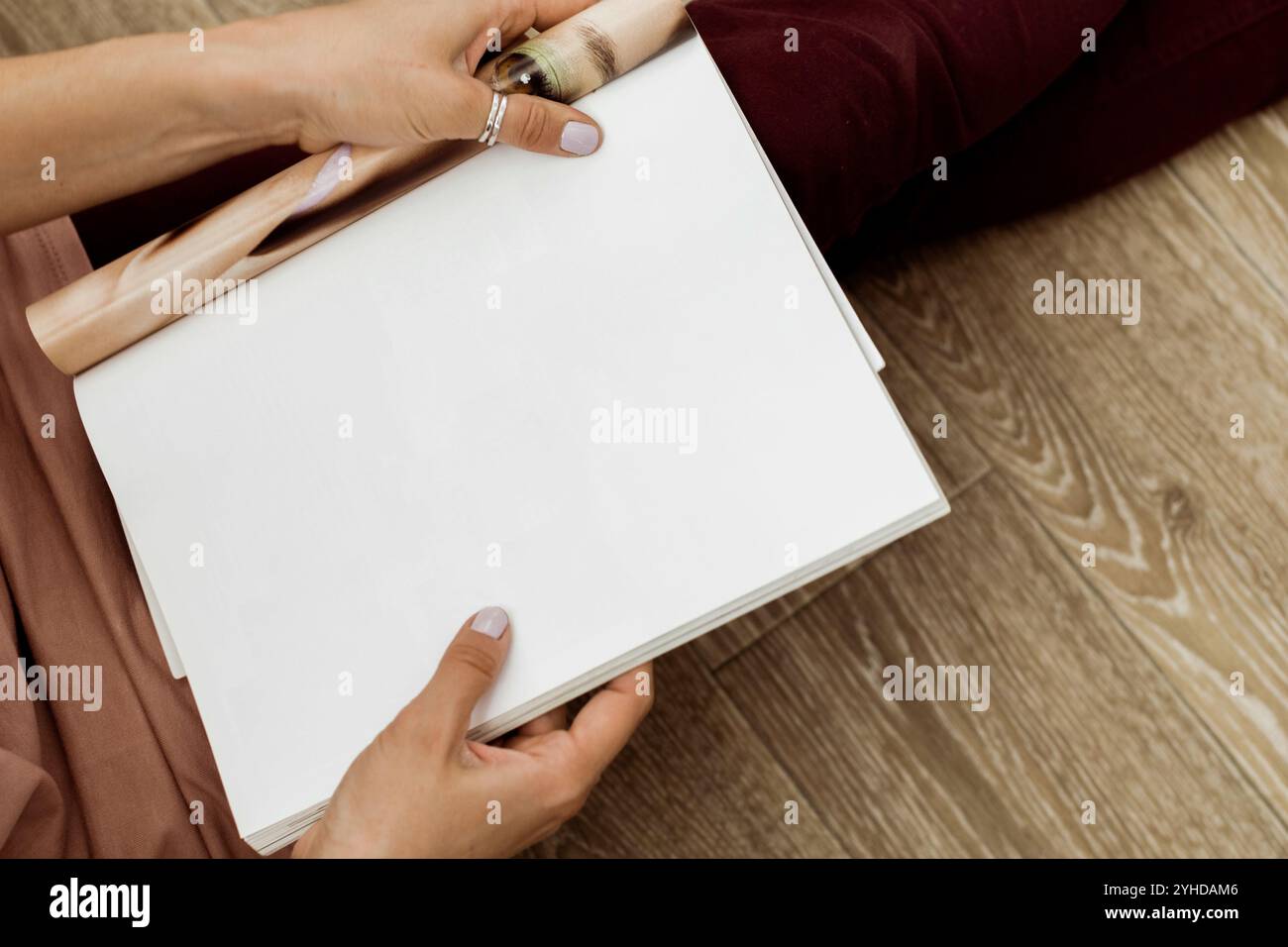 Young woman with a booklet with blank pages Stock Photo - Alamy