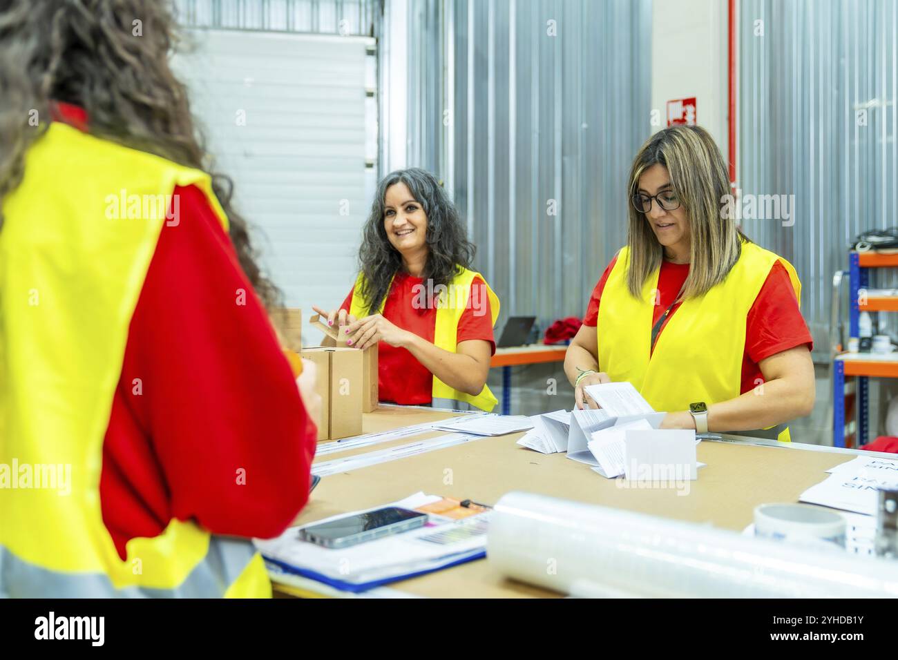 Work team of three women preparing shipments in a distribution ...