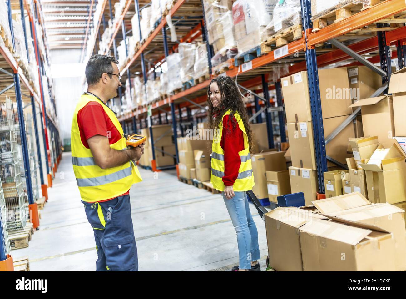 Male and female work colleagues dressing in safety yellow reflective ...