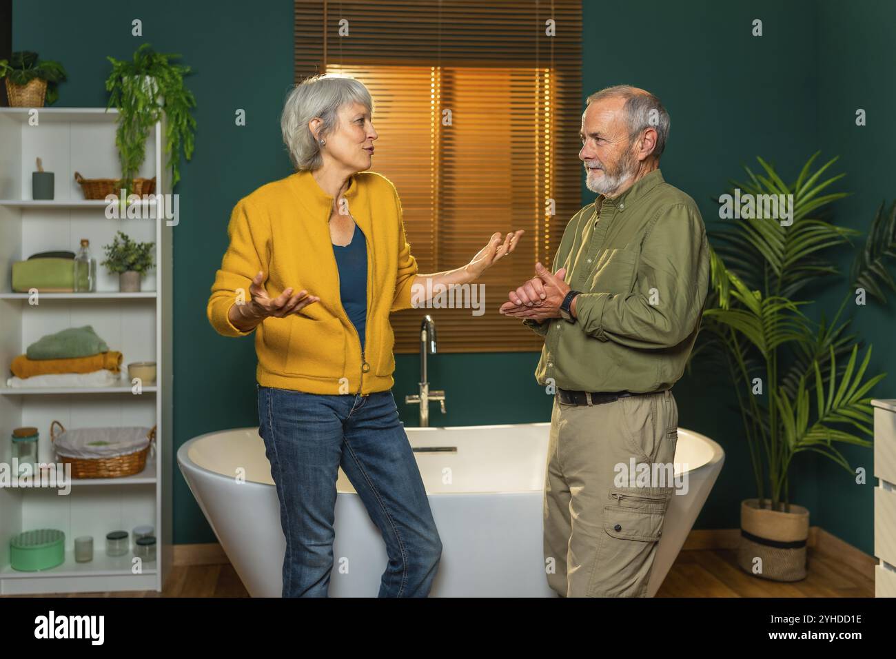 Casual caucasian senior couple discussing and talking standing together ...