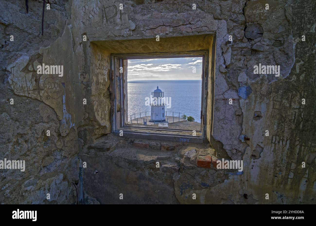 View of the new lighthouse from the window of a ruined building an old ...