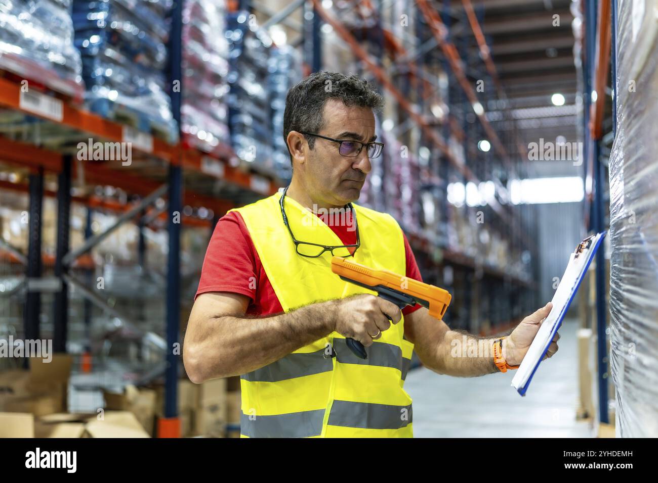 Mature caucasian man taking inventory using barcode reader and ...