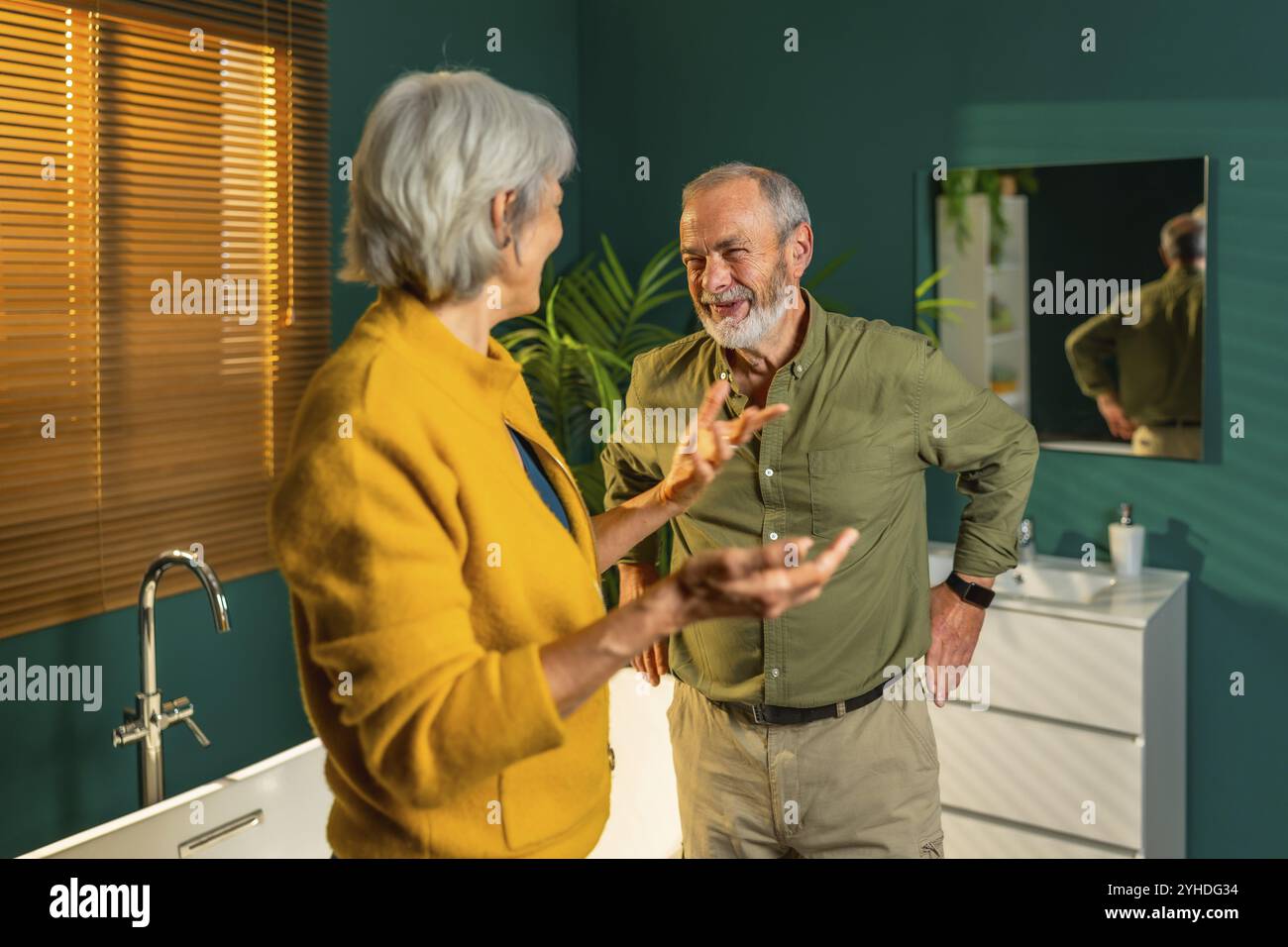 Senior caucasian male and female couple talking in the bathroom ...