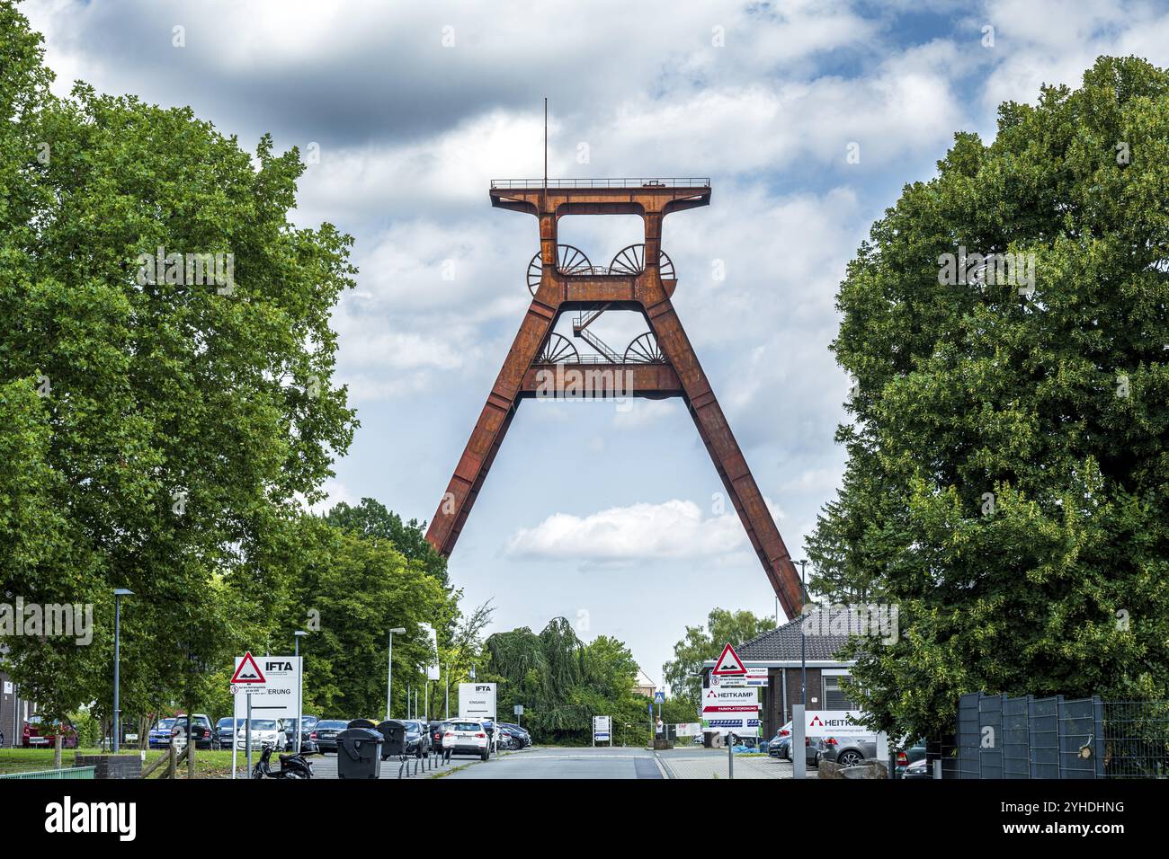 The winding tower towers above a tree-lined street with buildings and ...