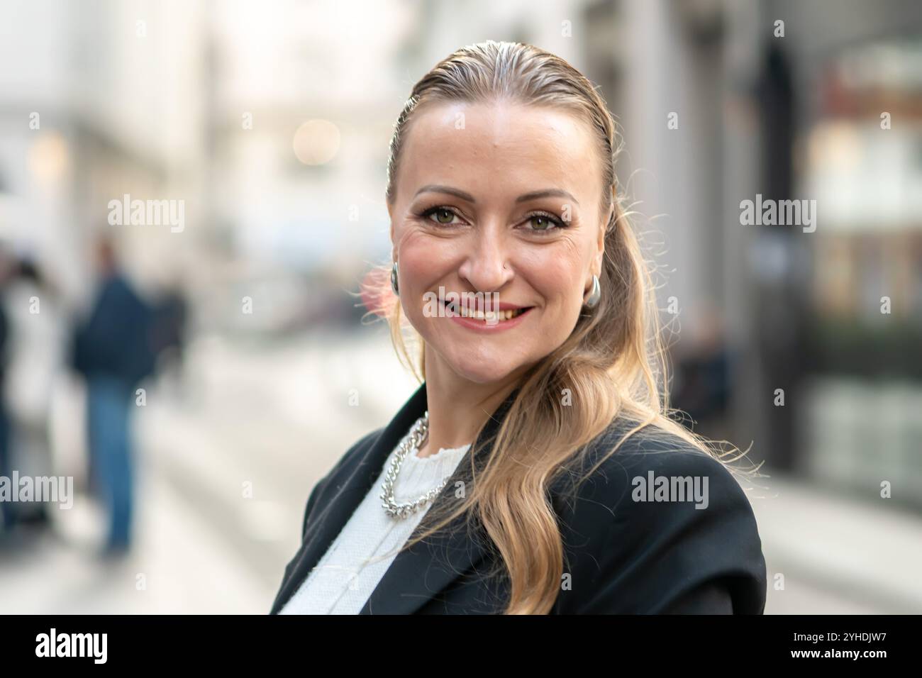 A woman of 35-40 years old with expressive facial features, European appearance, against a ...