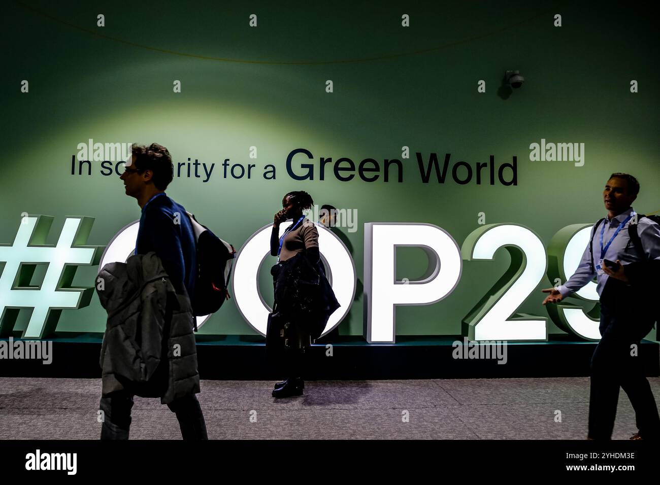 Participants walk past a logo of COP29, UN Climate Change Conference ...