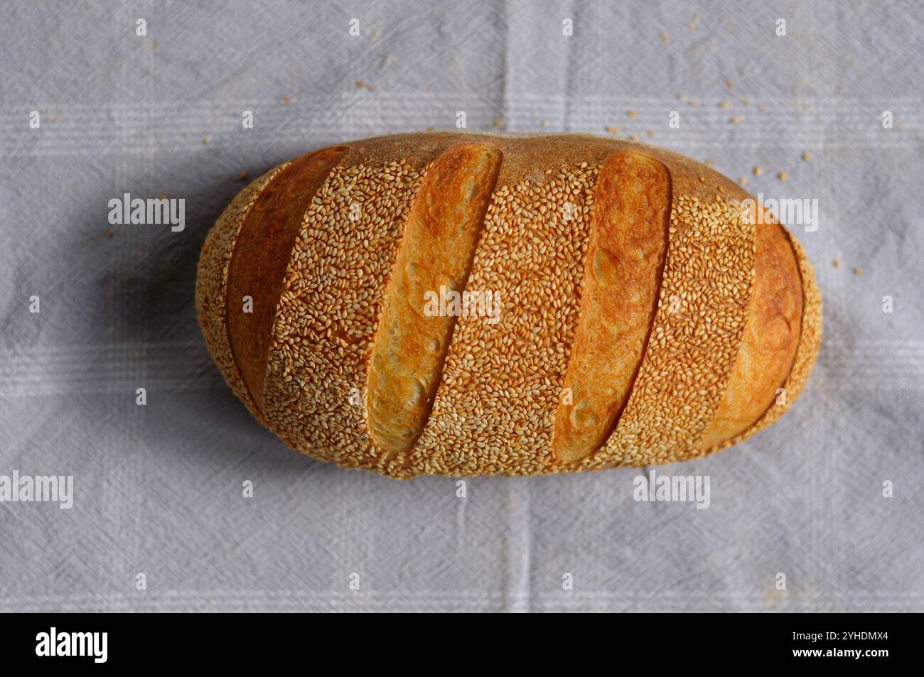 Single home-baked loaf of sourdough bread with sesam seeds Stock Photo ...