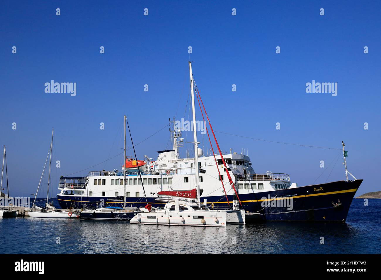 The Monet small cruising ship moored at Livadia Harbour, Tilos Island ...